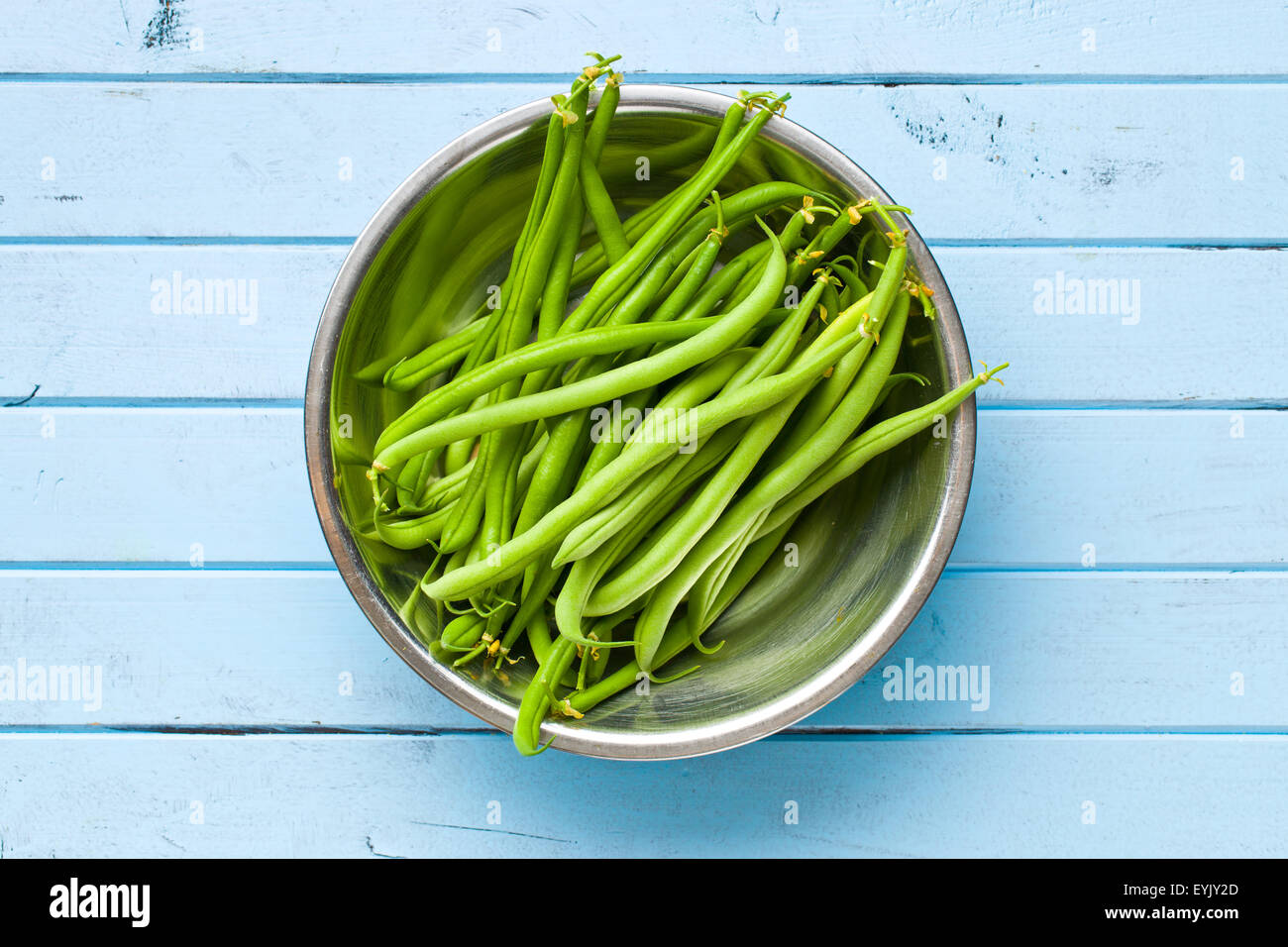 the green beans on blue kitchen table Stock Photo - Alamy