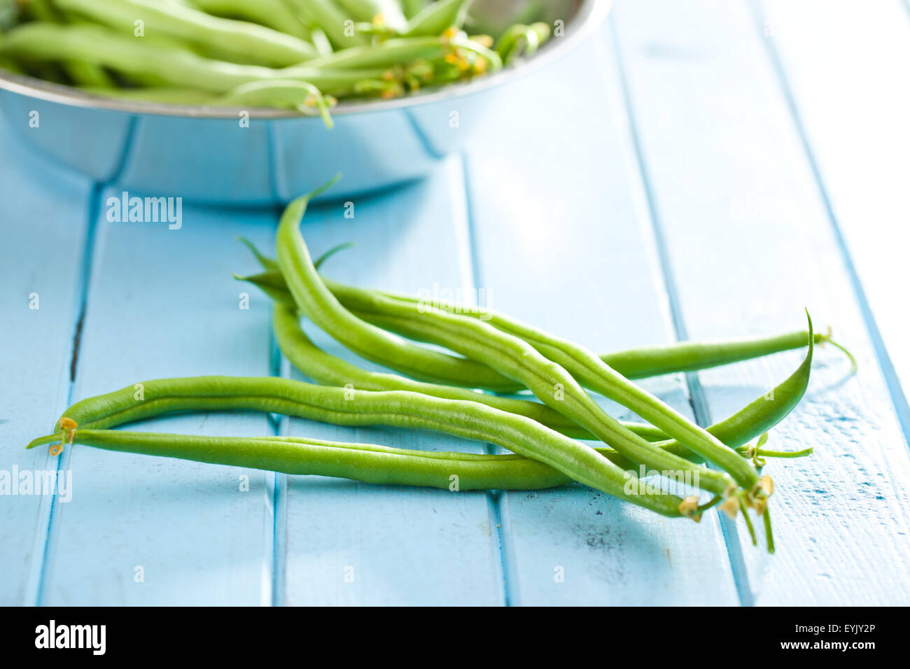 the green beans on blue kitchen table Stock Photo - Alamy