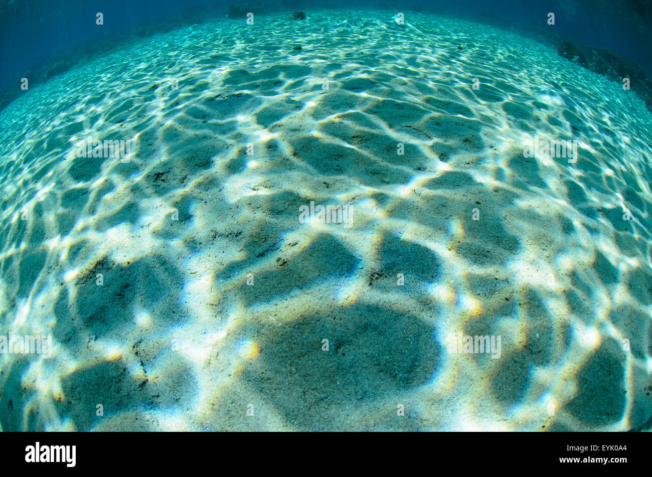 Light reflections from the surface reflect off shallow white sand ...
