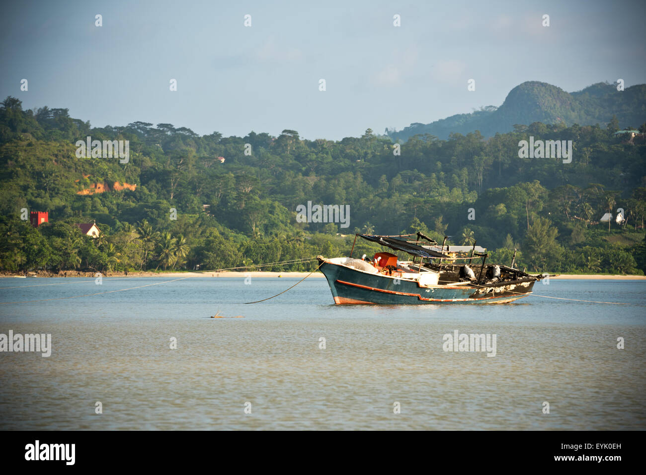 View of Seychelles coastline with an old boat on a foreground ...