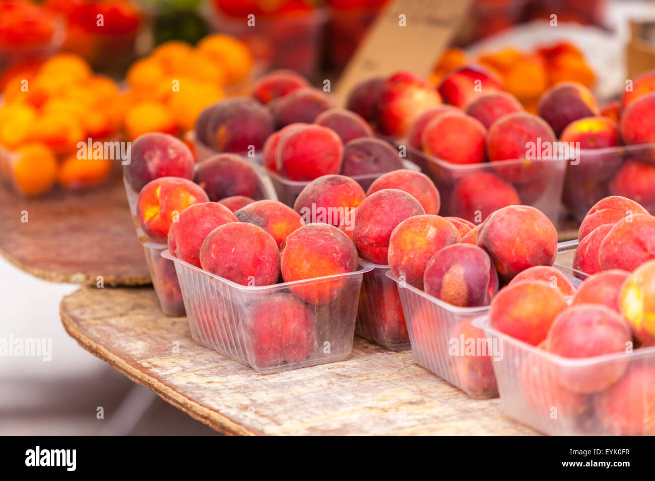 Ripe fresh peaches in a farmers market. Horizontal shot with a ...