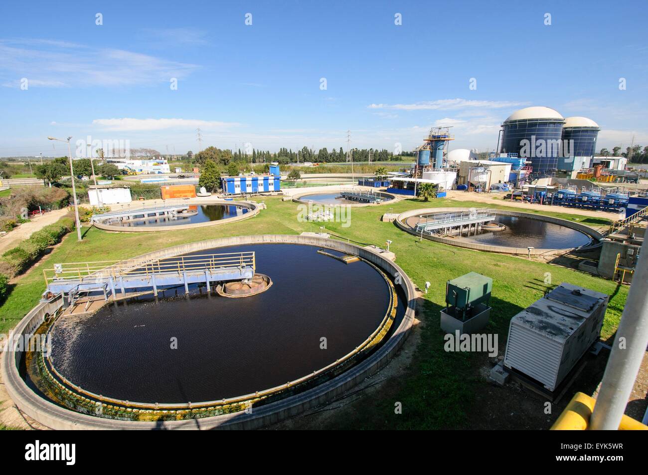 View of sludge treatment pool and storage tanks at sewage treatment ...