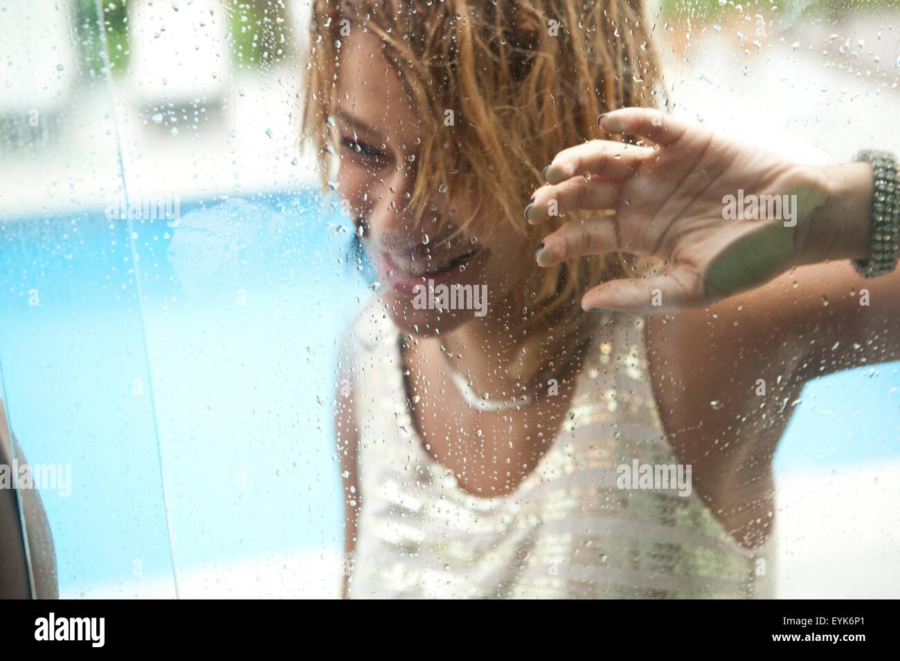 Woman behind wet window hi-res stock photography and images - Alamy