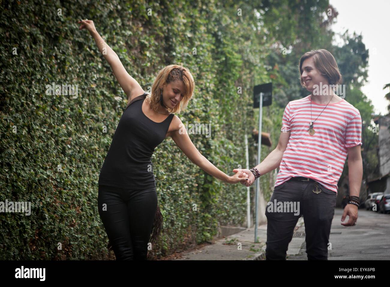 Young couple fooling around on suburban street Stock Photo - Alamy