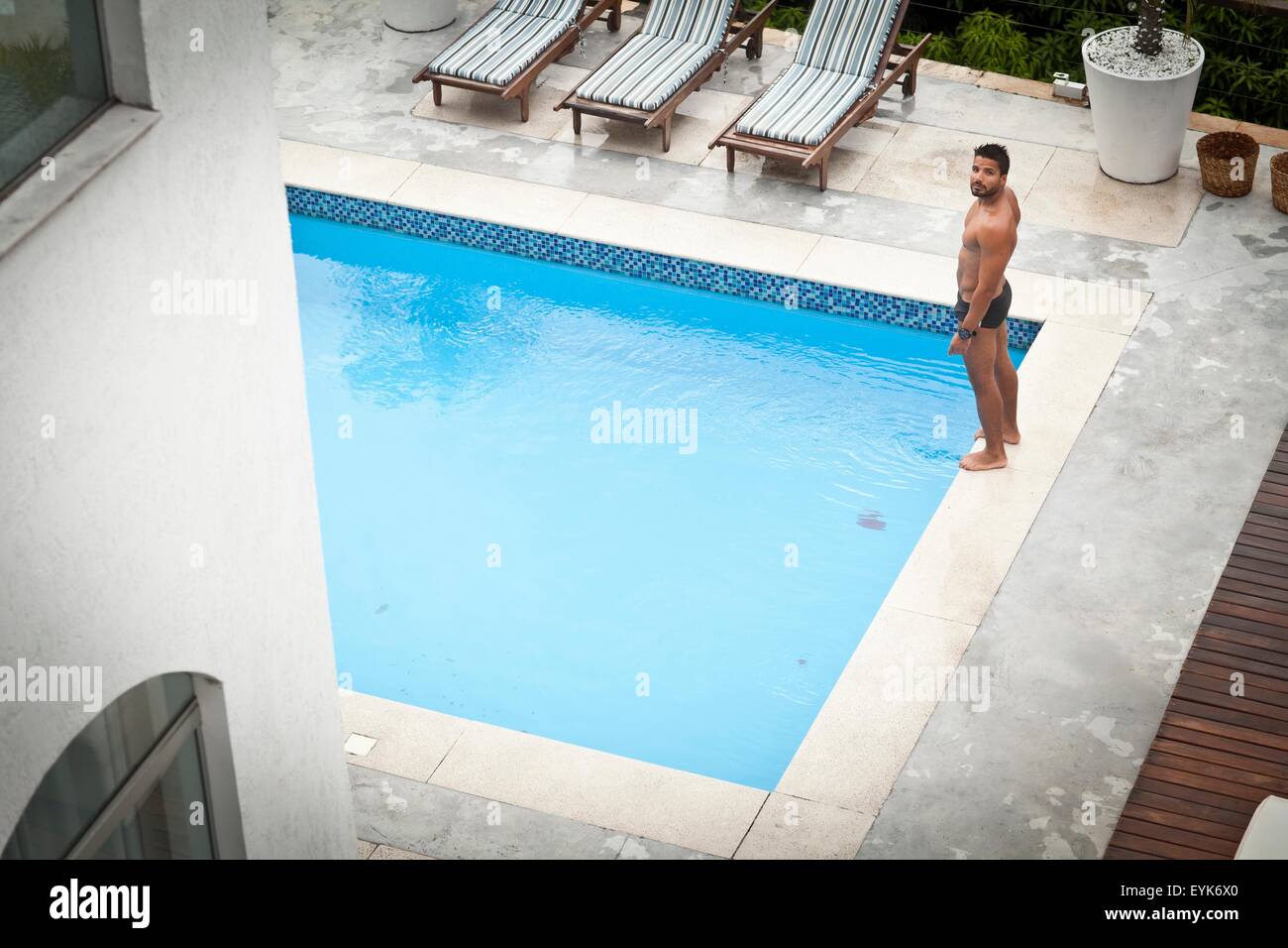 Man by poolside Stock Photo - Alamy