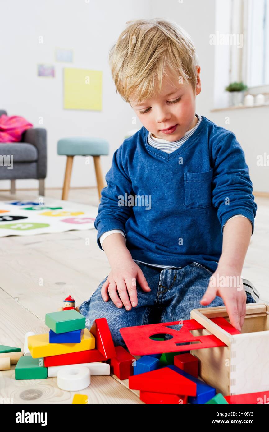 Boy playing with building blocks at home Stock Photo - Alamy