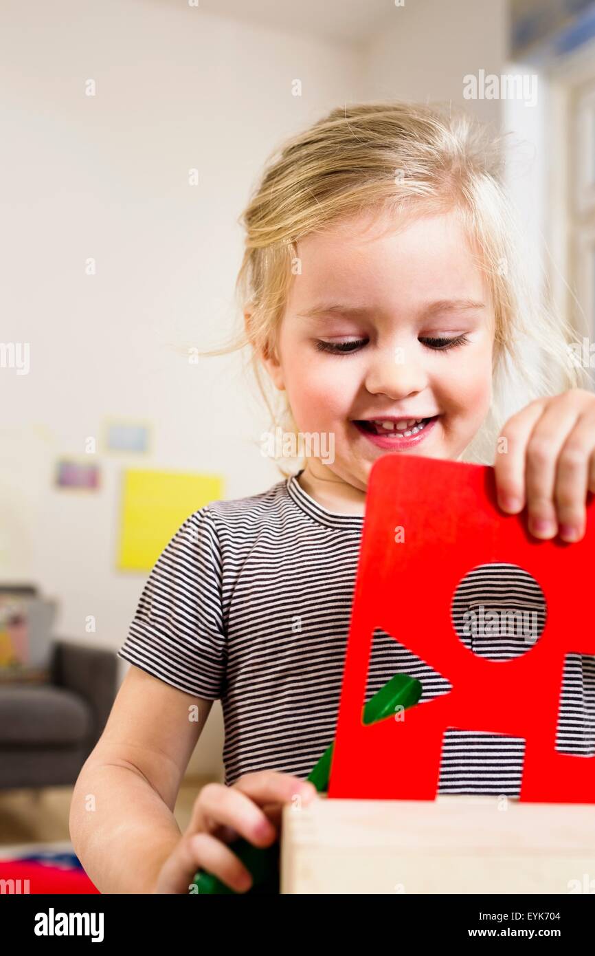 Girl playing with shape card Stock Photo - Alamy