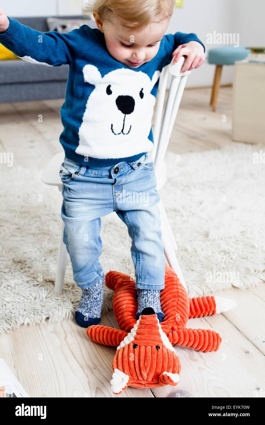 Boy stepping on toy Stock Photo - Alamy