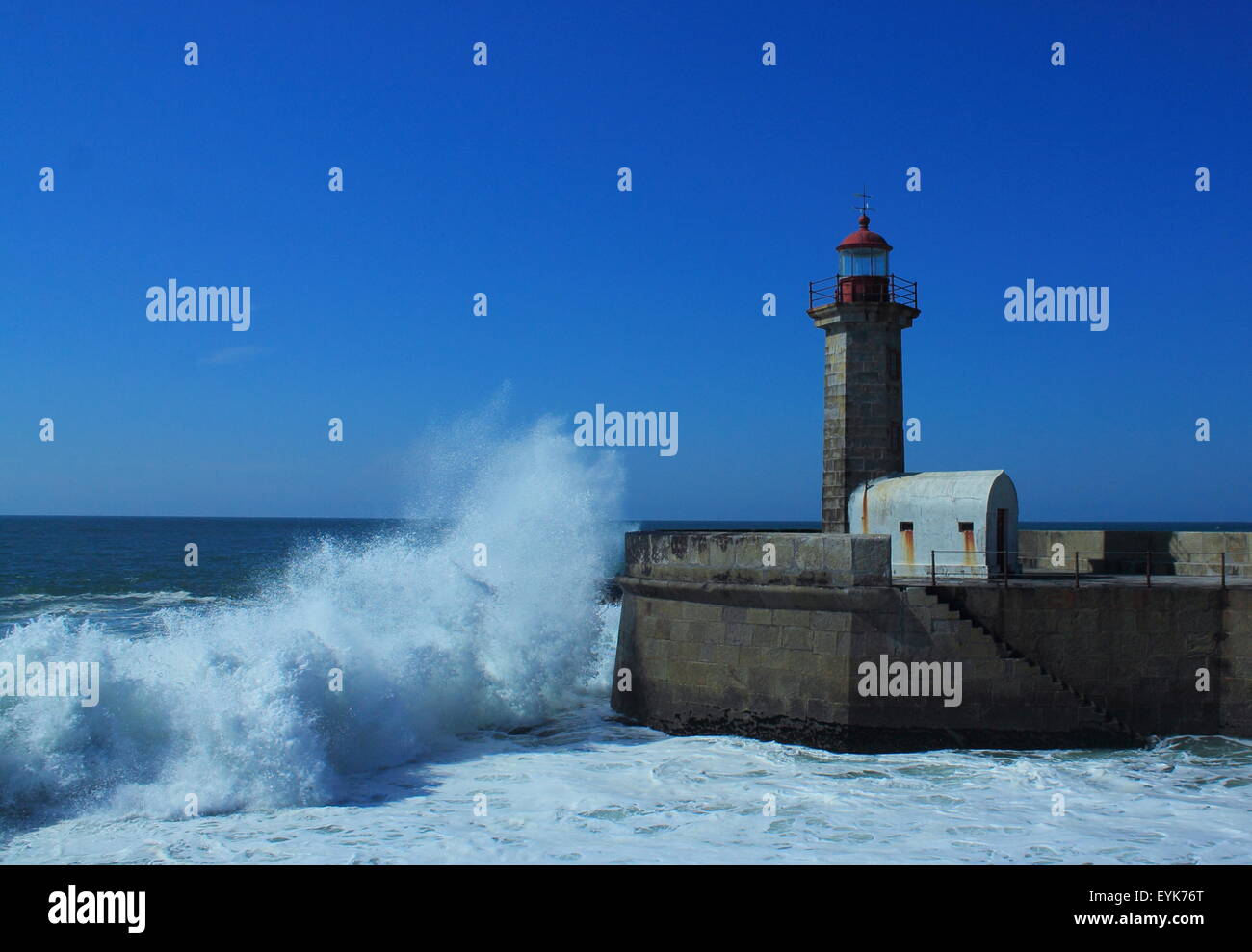 Waves crashing on lighthouse Stock Photo - Alamy