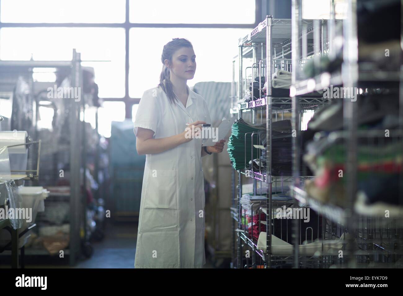 Woman working in laundry Stock Photo - Alamy