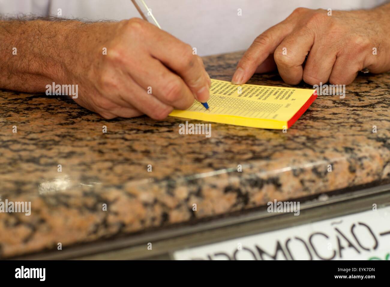 Close up of male hands writing order in juice bar, Copacabana town, Rio ...