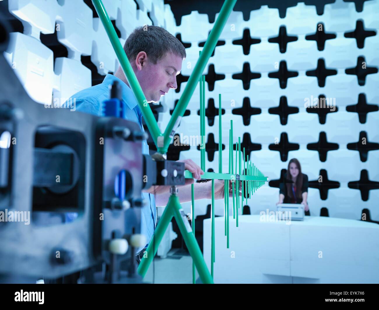 Engineers checking a bilog antenna for electromagnetic compatibility ...