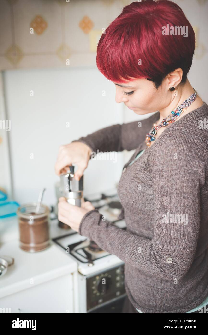 Young woman at home making coffee Stock Photo - Alamy