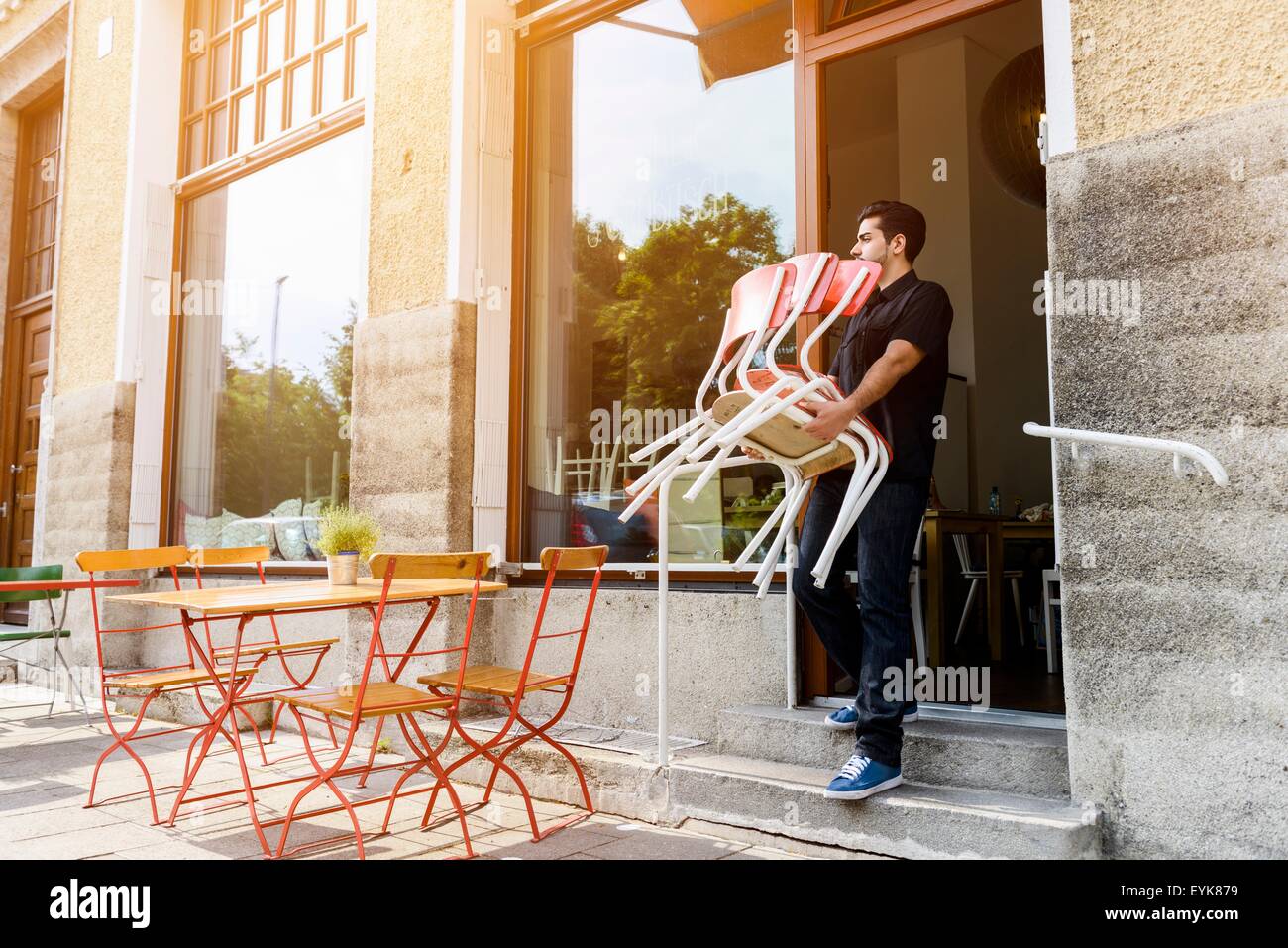 Men carrying chairs hi-res stock photography and images - Alamy