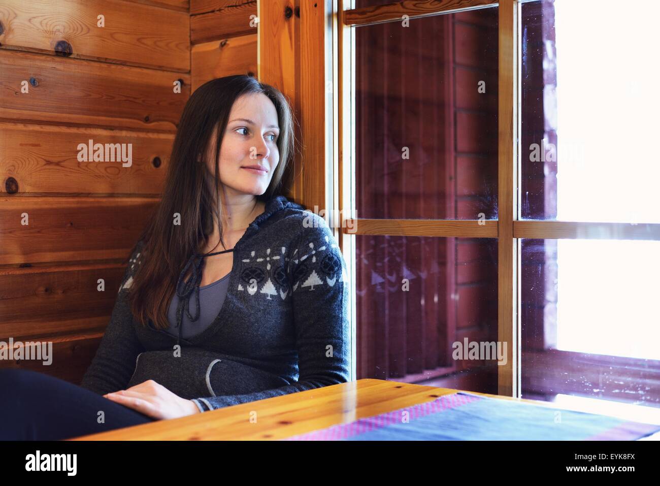 Portrait of young woman gazing out of cabin window Stock Photo - Alamy