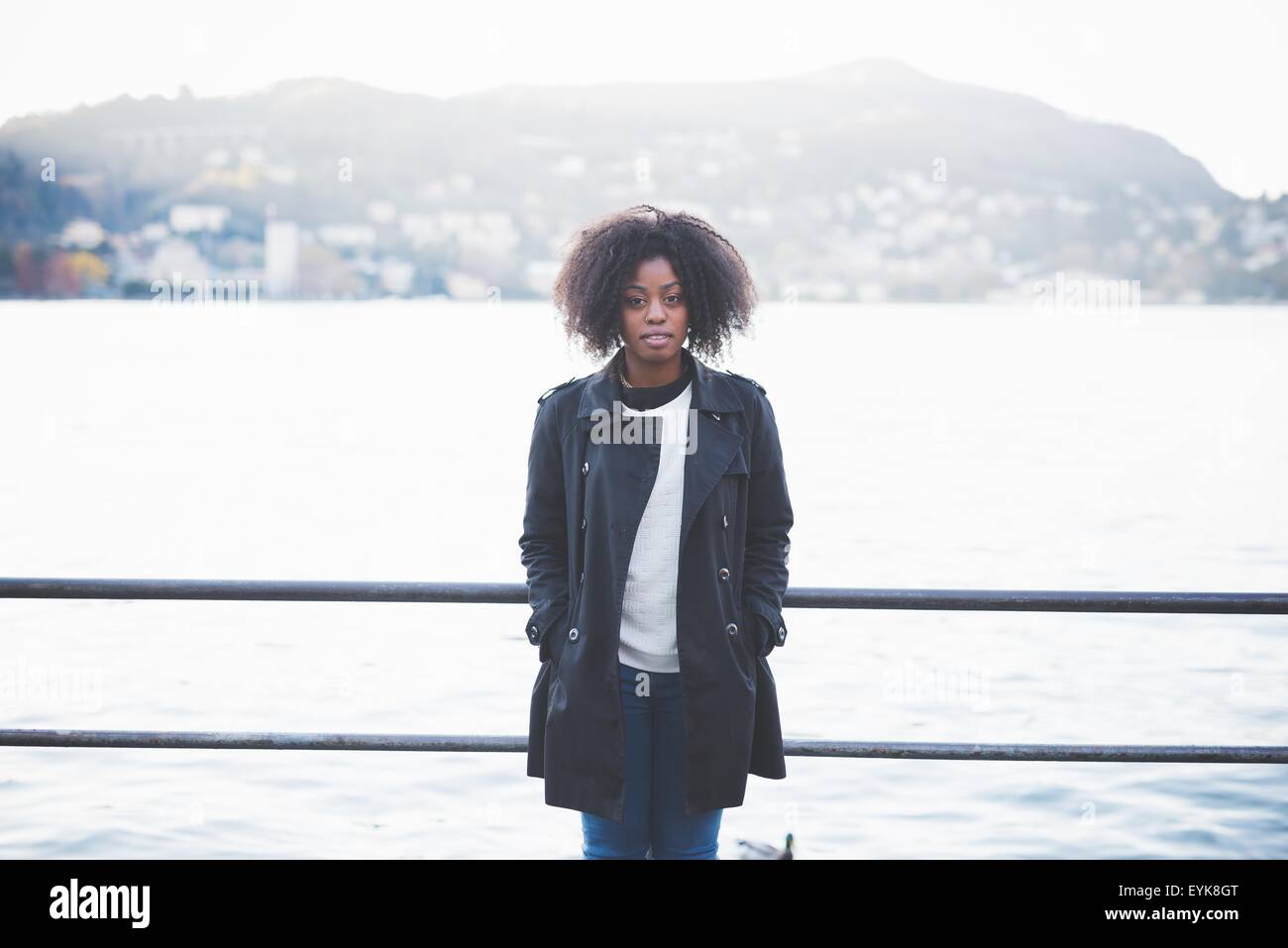 Portrait of young woman leaning against railings at Lake Como, Como ...
