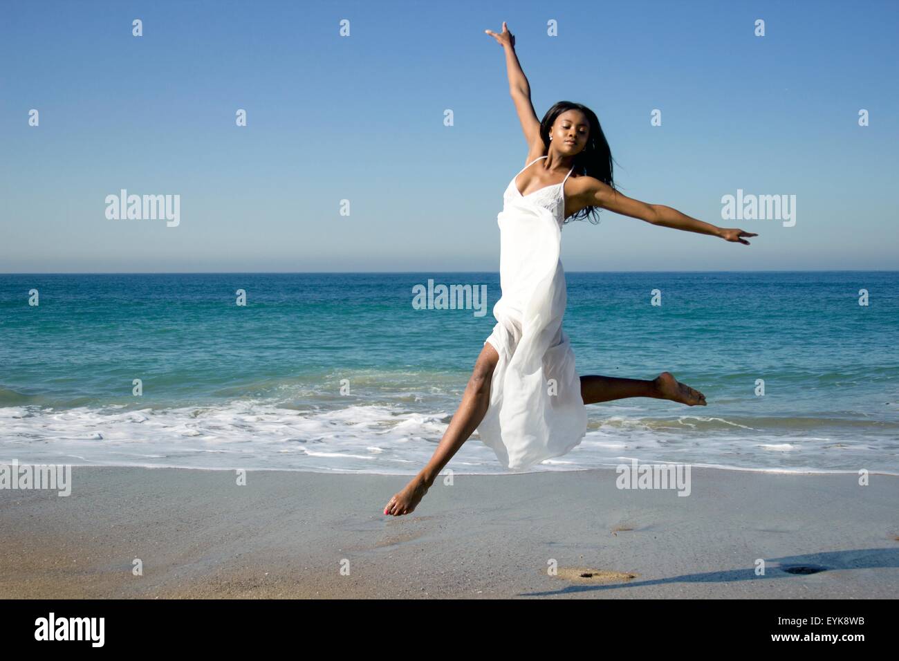 Young female dancer leaping mid air on beach Stock Photo - Alamy