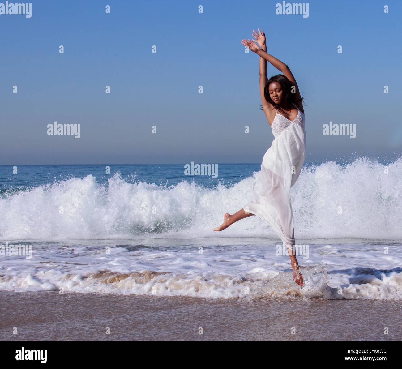 Young female dancer leaping mid air in ocean waves Stock Photo - Alamy