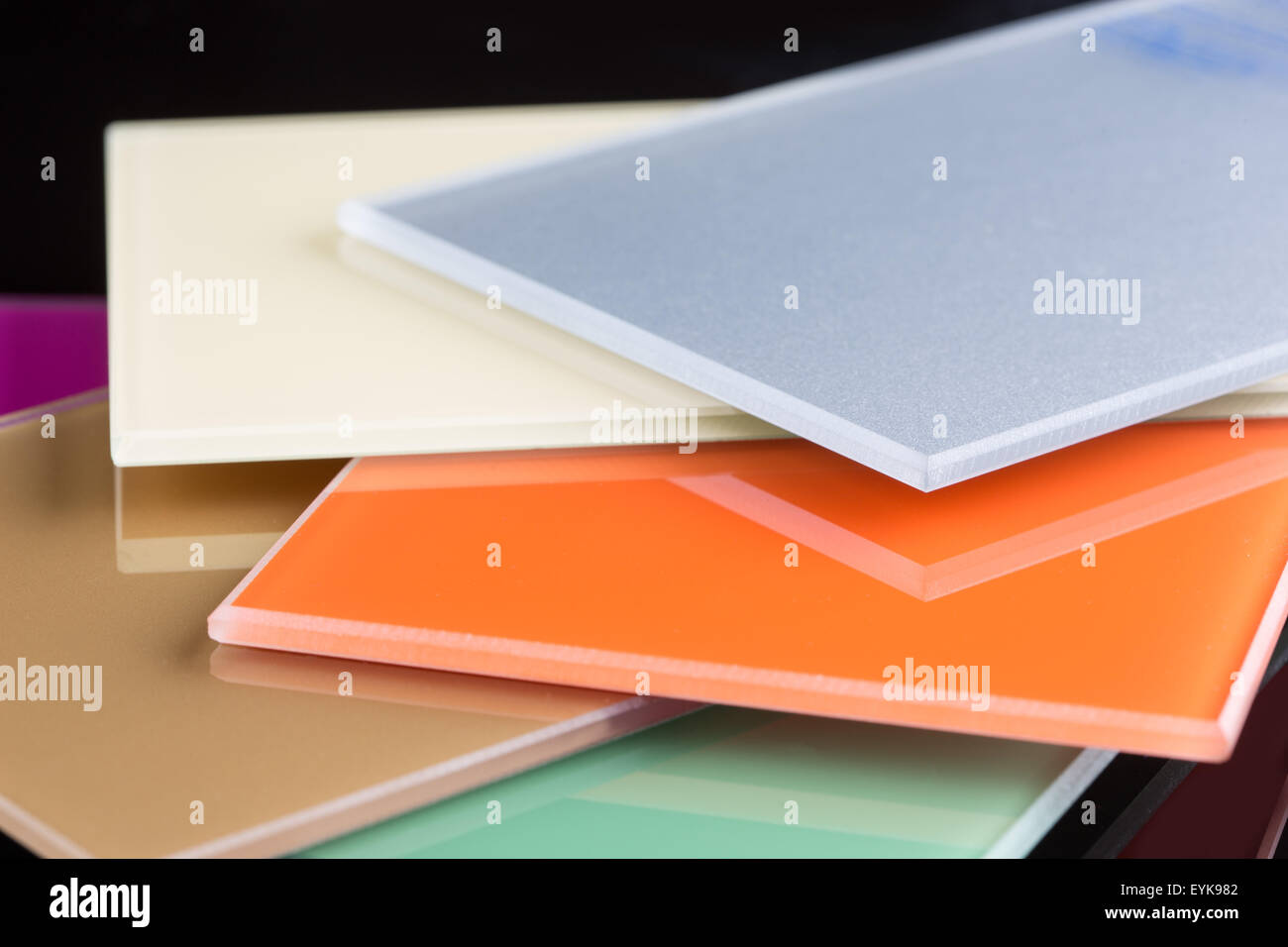 a stack of colored glass on a black background. glass sheets Stock ...