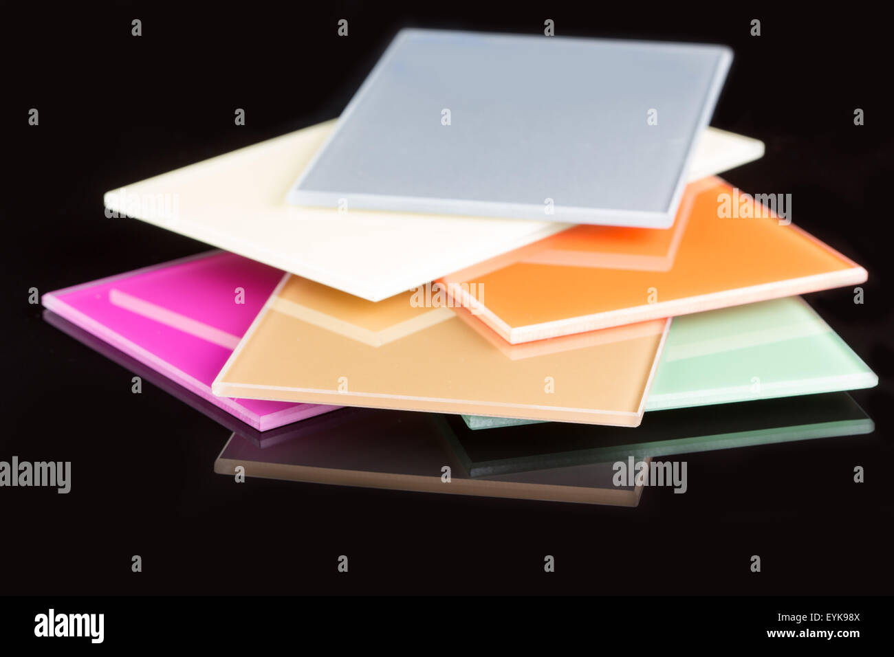 a stack of colored glass on a black background. glass sheets Stock ...