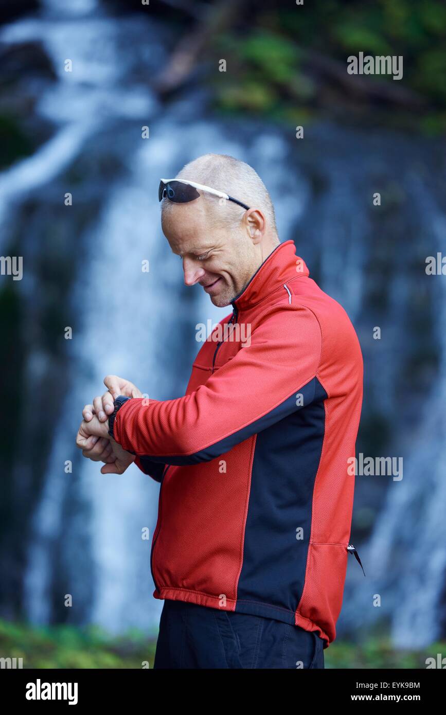 Mature man checking watch Stock Photo - Alamy