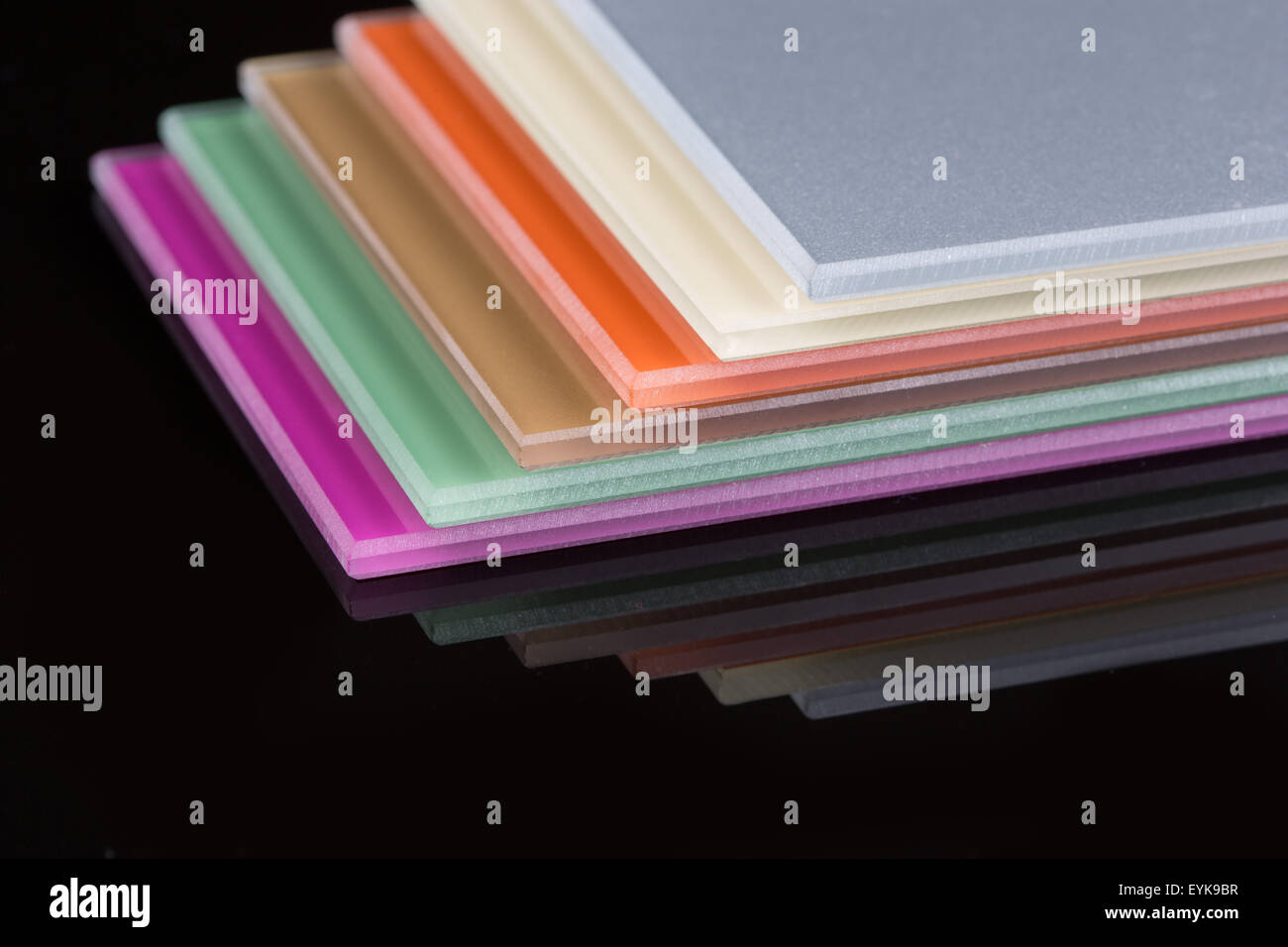 a stack of colored glass on a black background. glass sheets Stock ...