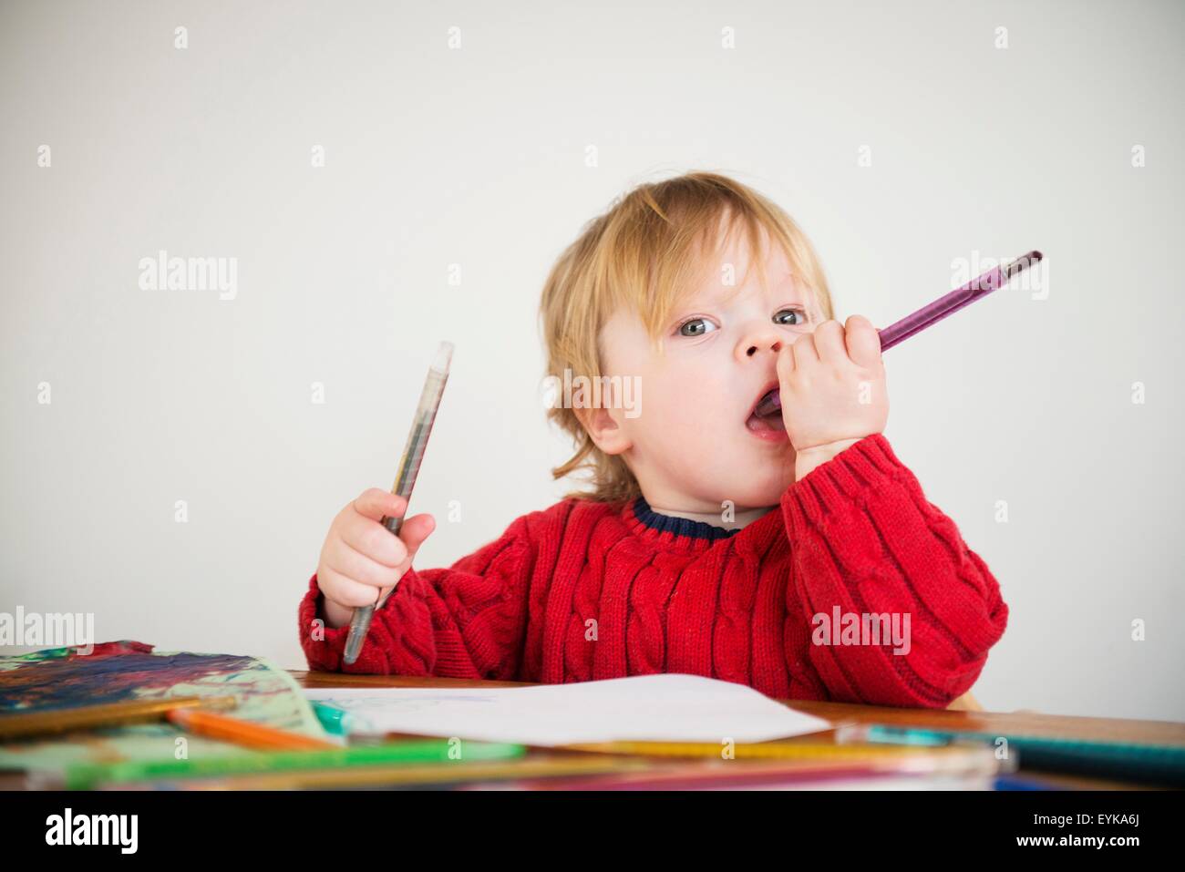Boy holding colouring pencils Stock Photo - Alamy