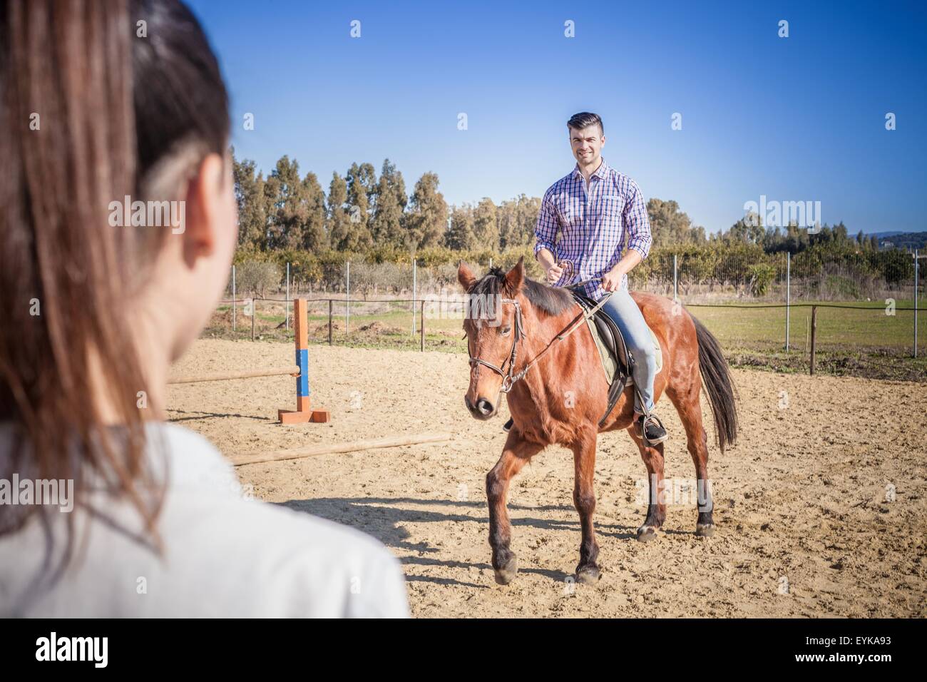 Young man riding horse Stock Photo - Alamy