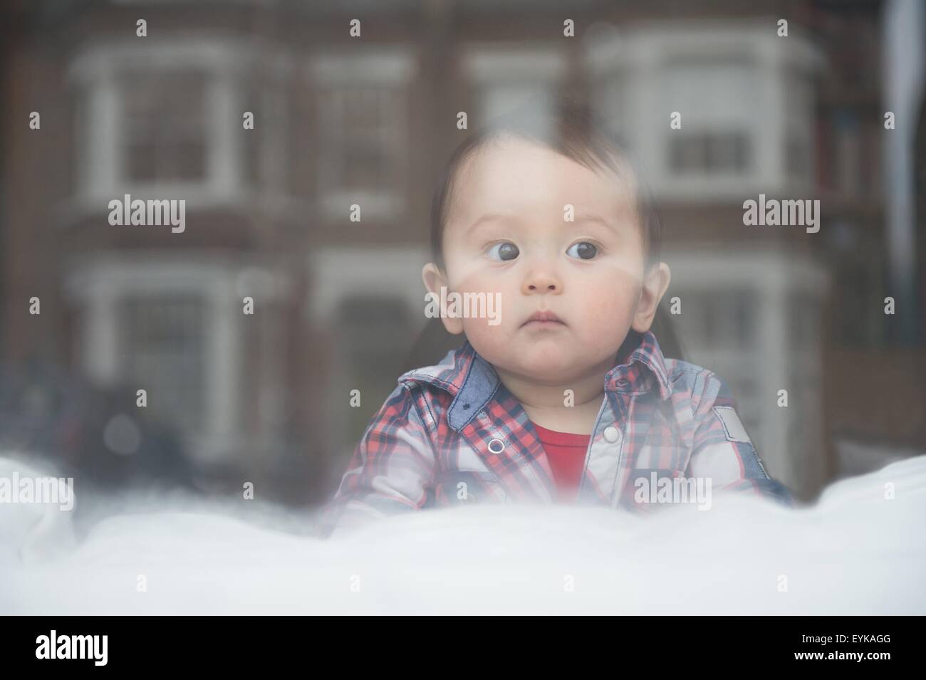 Baby boy looking out of window, view through window Stock Photo - Alamy