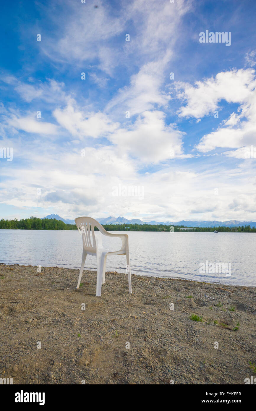 Sandy lake beach in Wasilla, Alaska holds a white plastic chair Stock ...