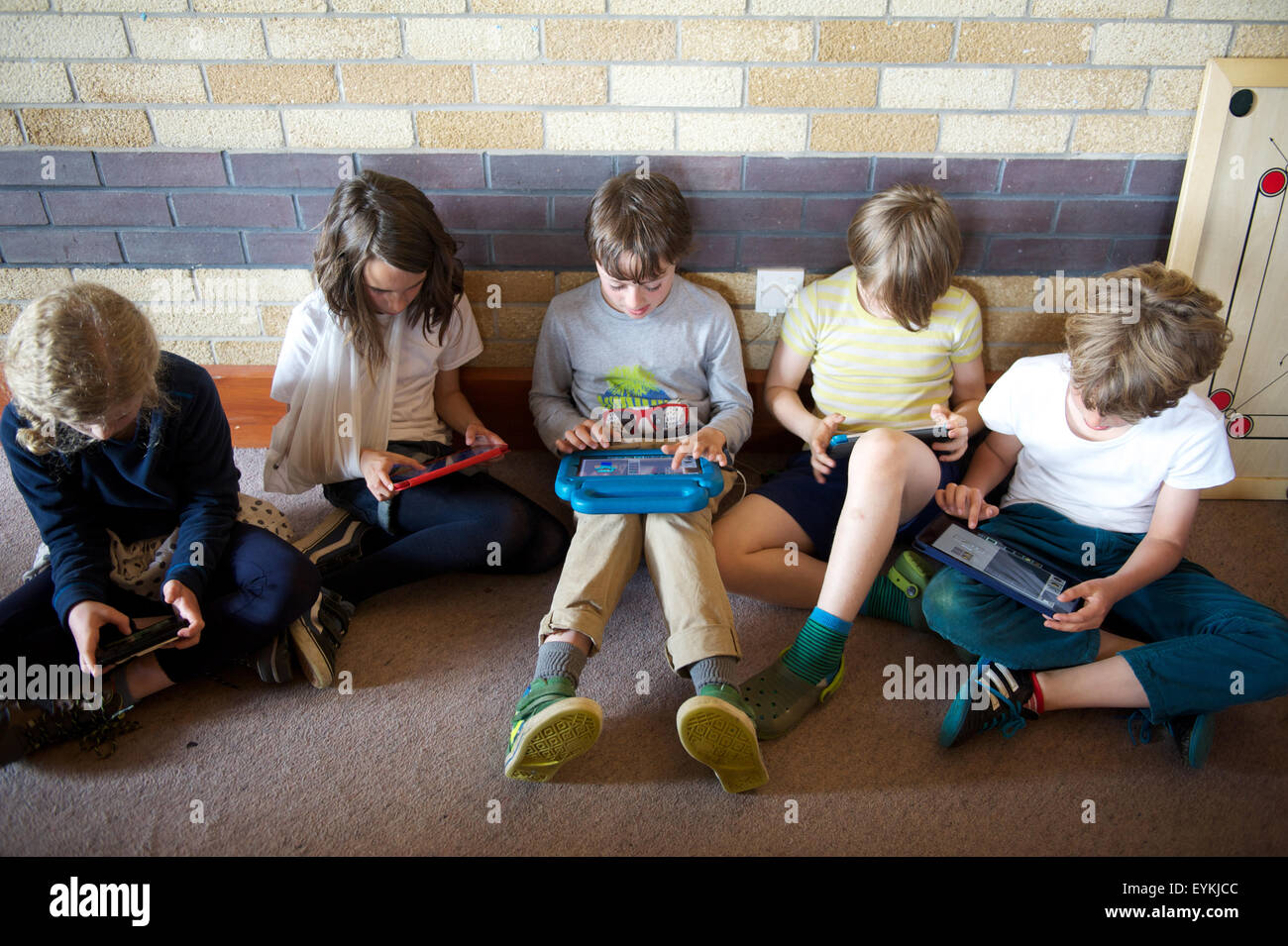 Morning screen time for a group of friends on holiday together Stock ...