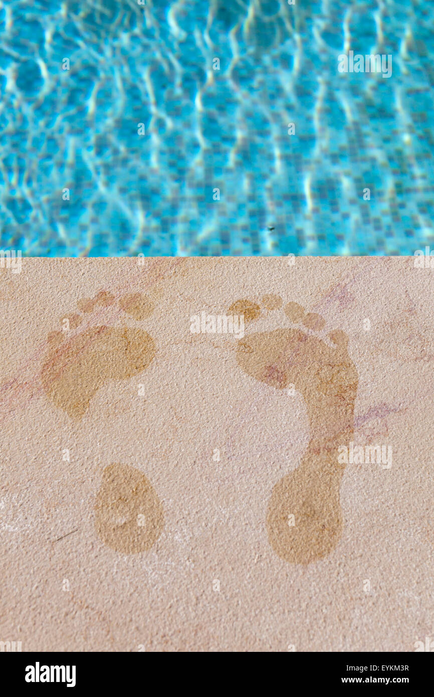 Footprints at pool edge Stock Photo - Alamy