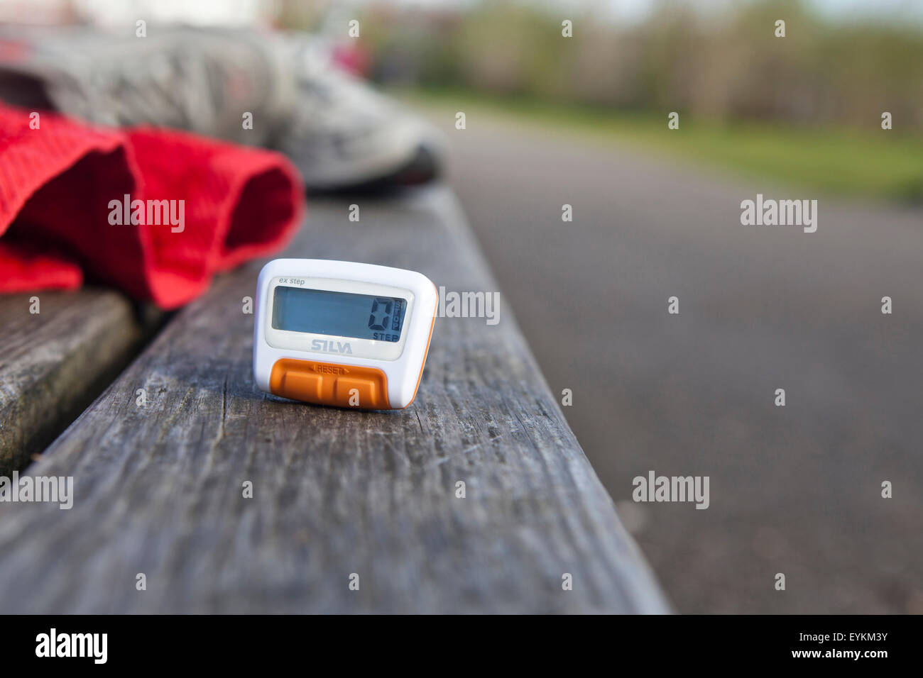 Step counter, towel and run shoes on a park-bench Stock Photo - Alamy