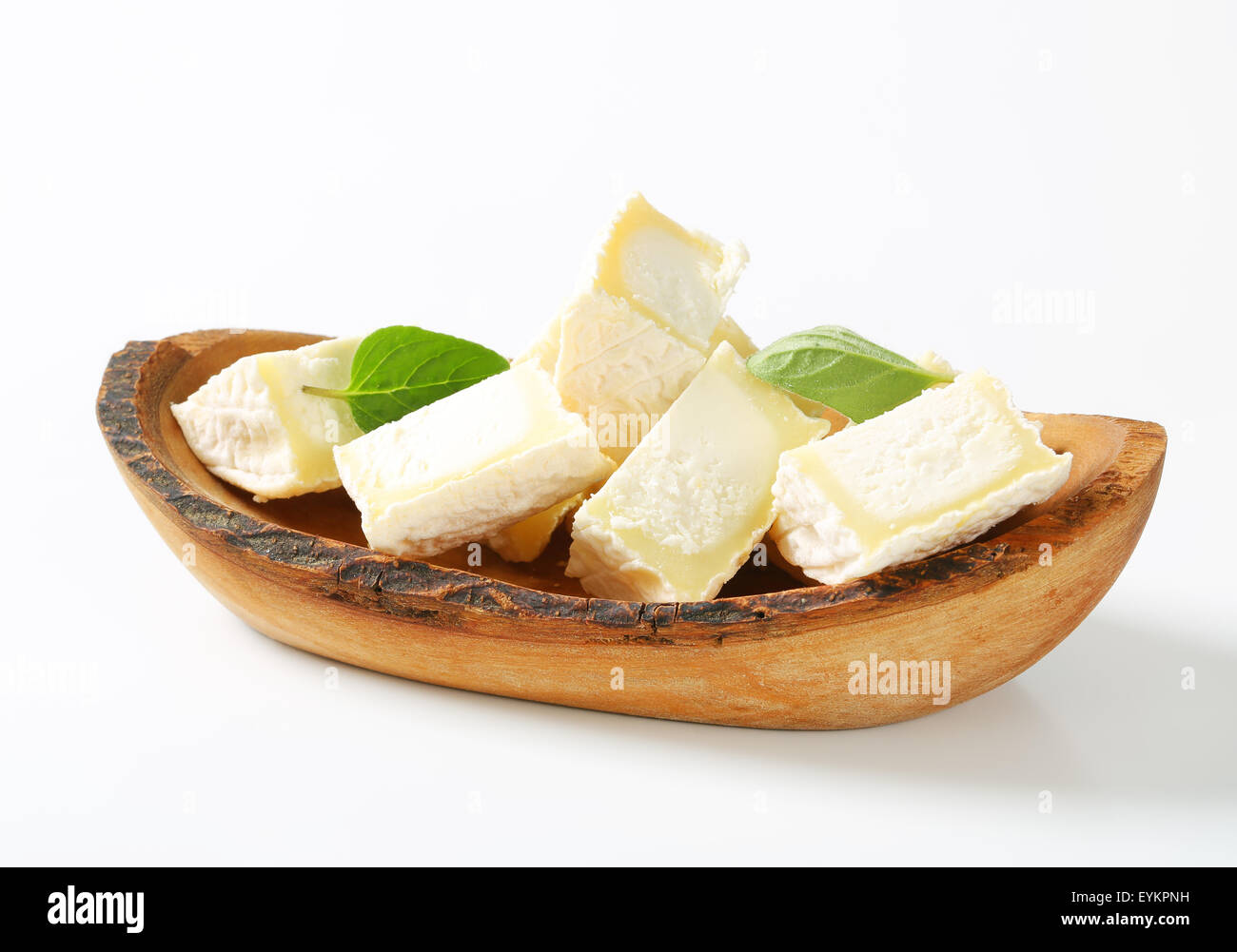 Pieces of goat cheese in natural edge bowl Stock Photo - Alamy