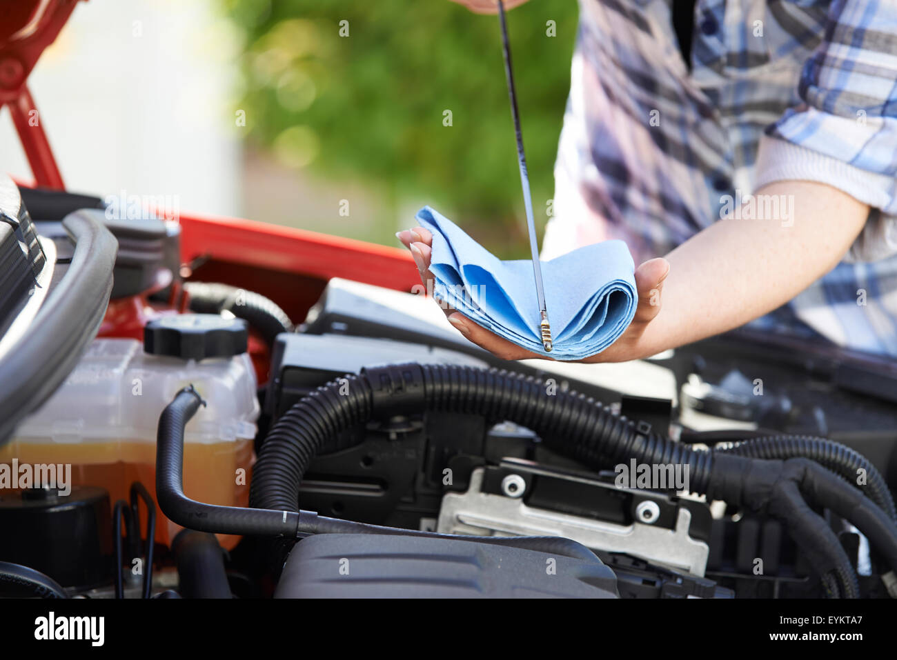 Close-Up Of Woman Checking Car Engine Oil Level On Dipstick Stock Photo ...