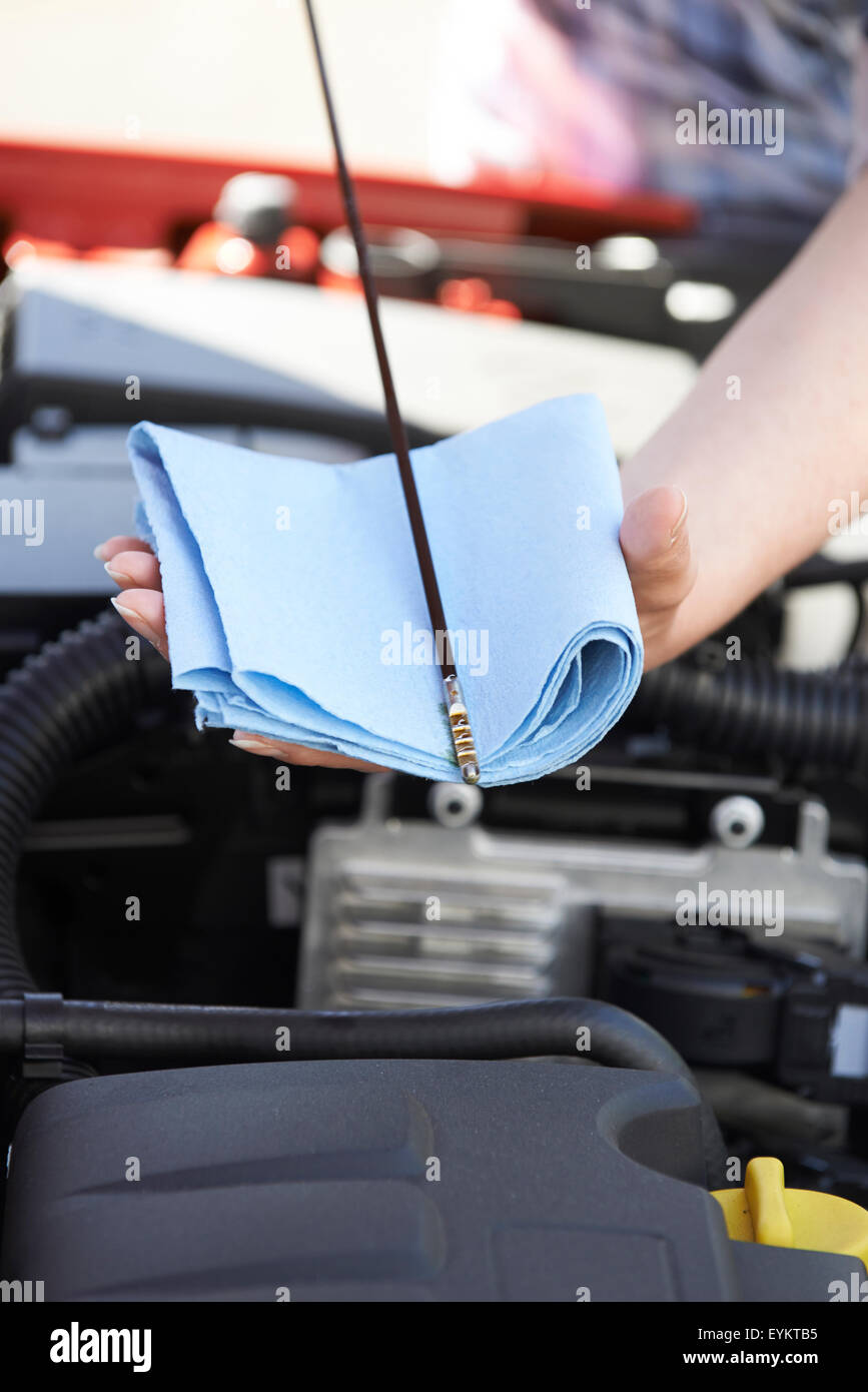Close-Up Of Woman Checking Car Engine Oil Level On Dipstick Stock Photo ...