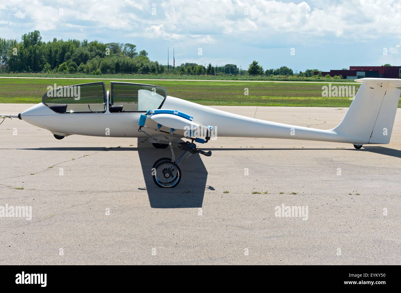 glider or sailplane on runway with canopy open at municipal airport in ...