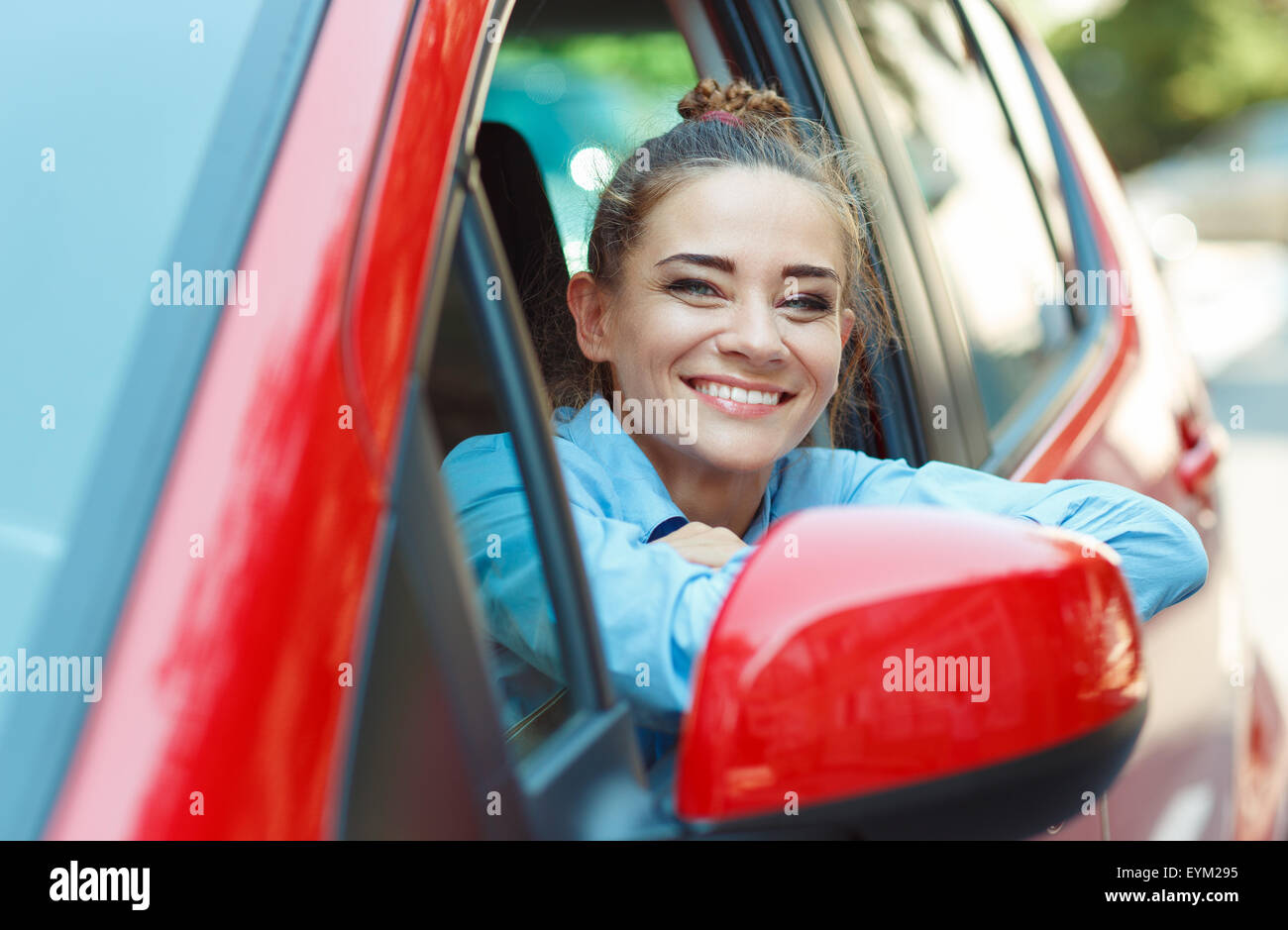 Young smiling woman driving her car Stock Photo - Alamy