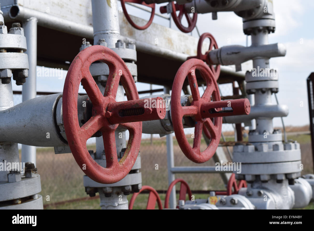 Oil valve with rocking in the background Stock Photo - Alamy