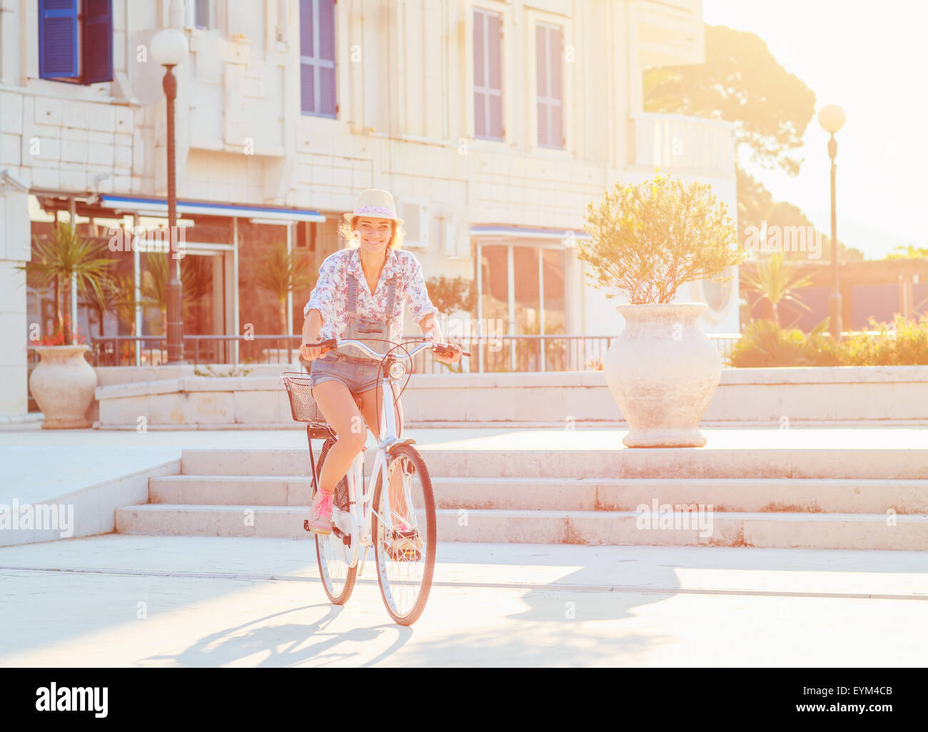 Beautiful happy woman riding on bike outdoors Stock Photo - Alamy