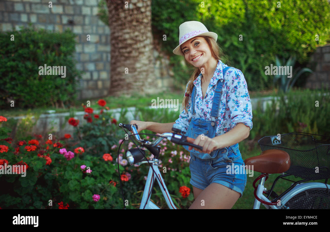 Beautiful happy woman riding on bike outdoors Stock Photo - Alamy