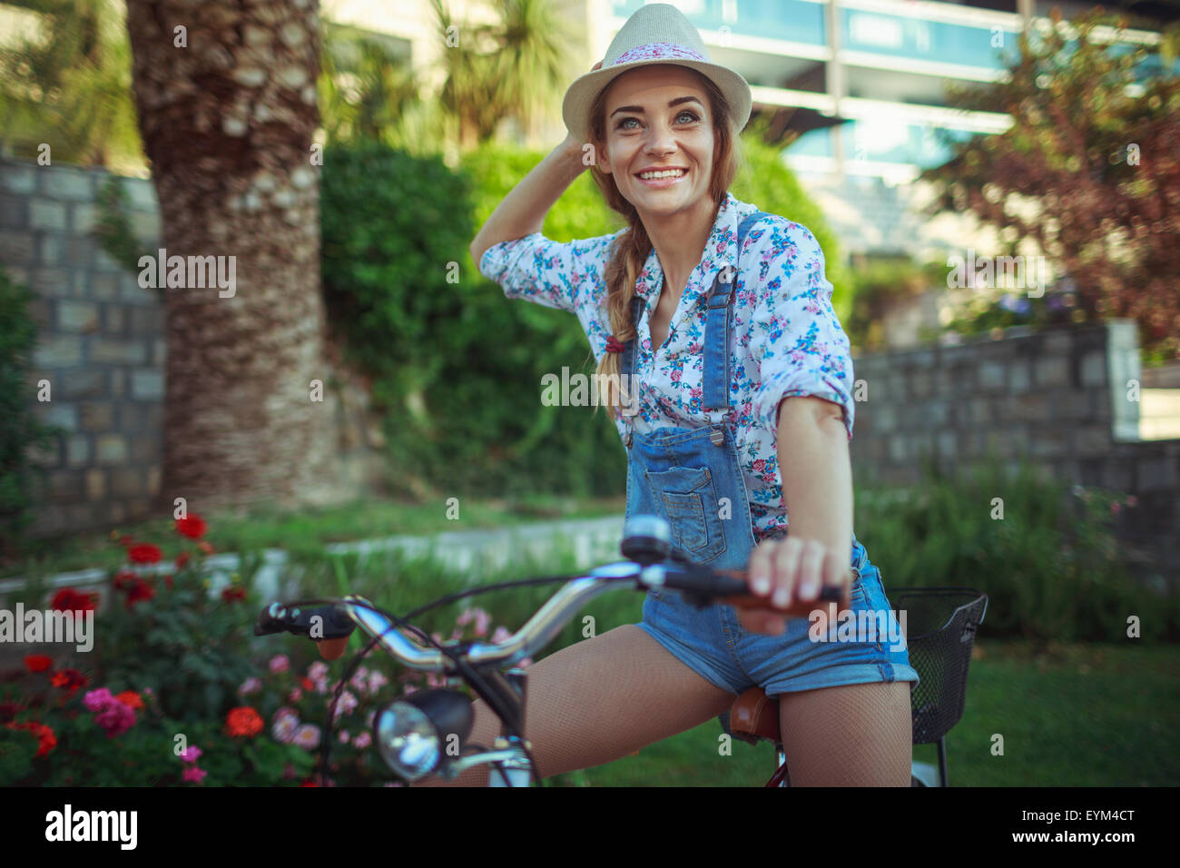 Beautiful happy woman riding on bike outdoors Stock Photo - Alamy