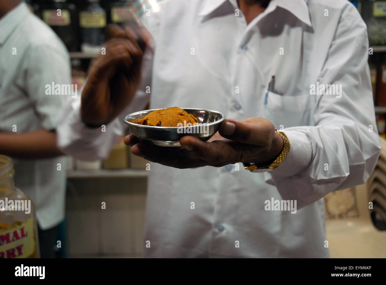 Man with dish of curry powder Mumbai, Maharashtra, India Stock Photo ...