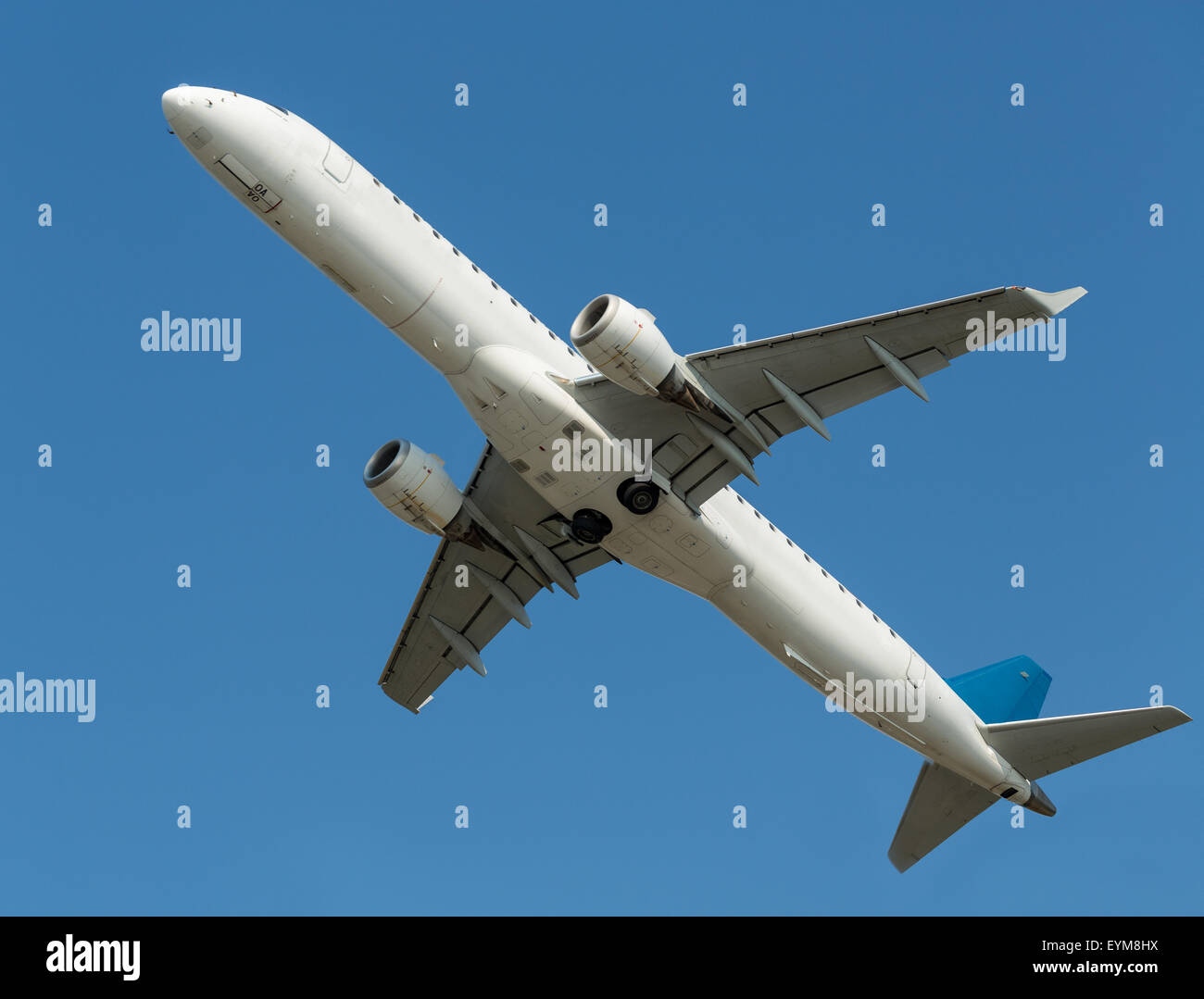 Airplane in the blue sky Stock Photo - Alamy