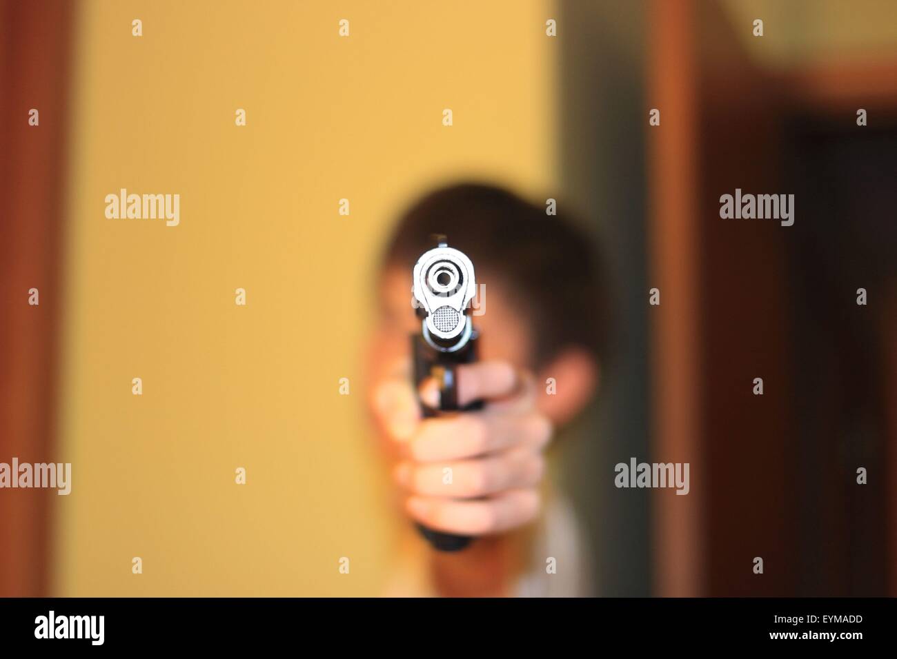 Photograph of a child pointing a handgun with focus on gun Stock Photo ...