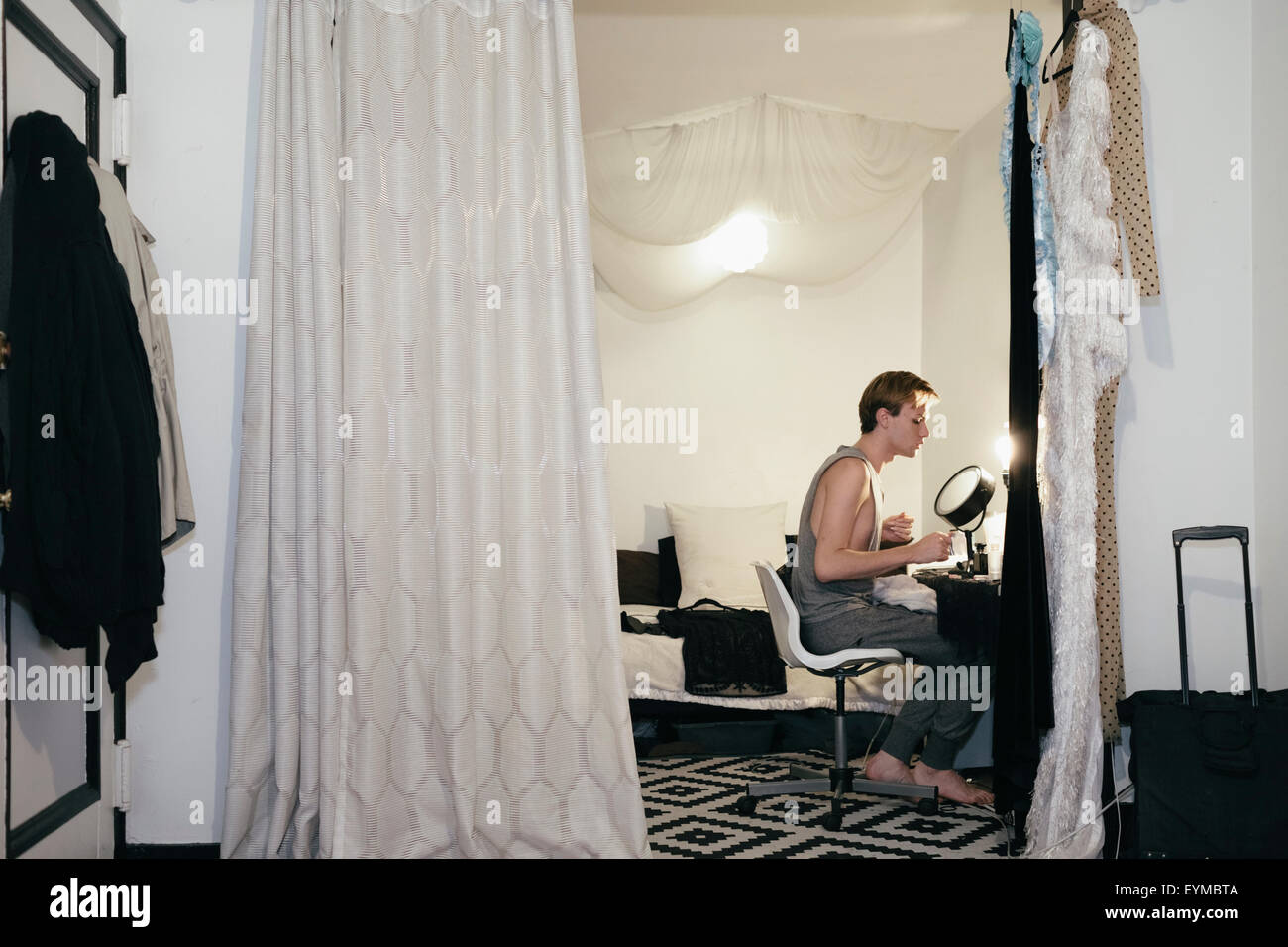 Male drag queen putting on make up and dressing up in prepration for a ...