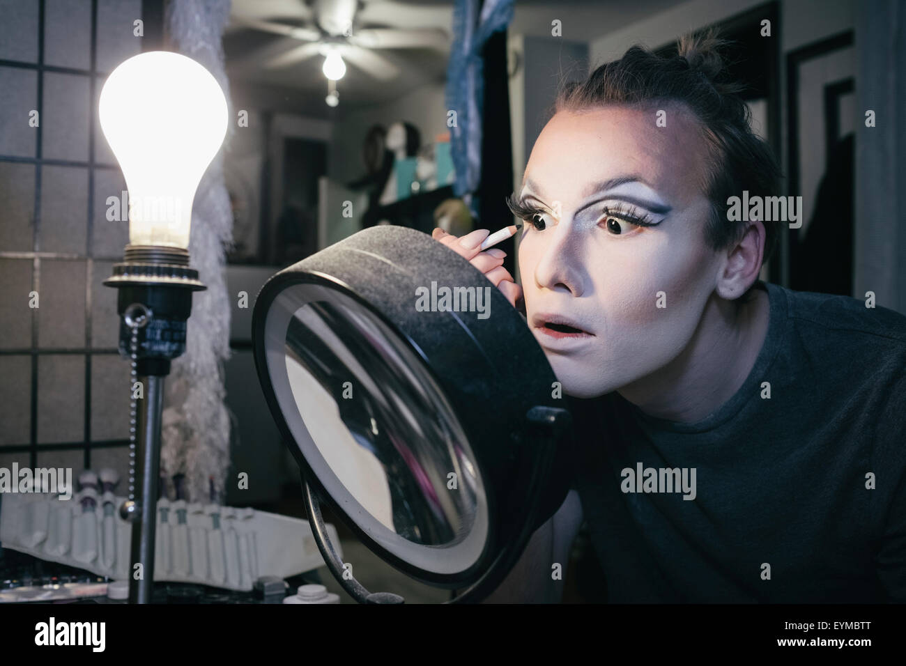 Male drag queen putting on make up and dressing up in prepration for a ...