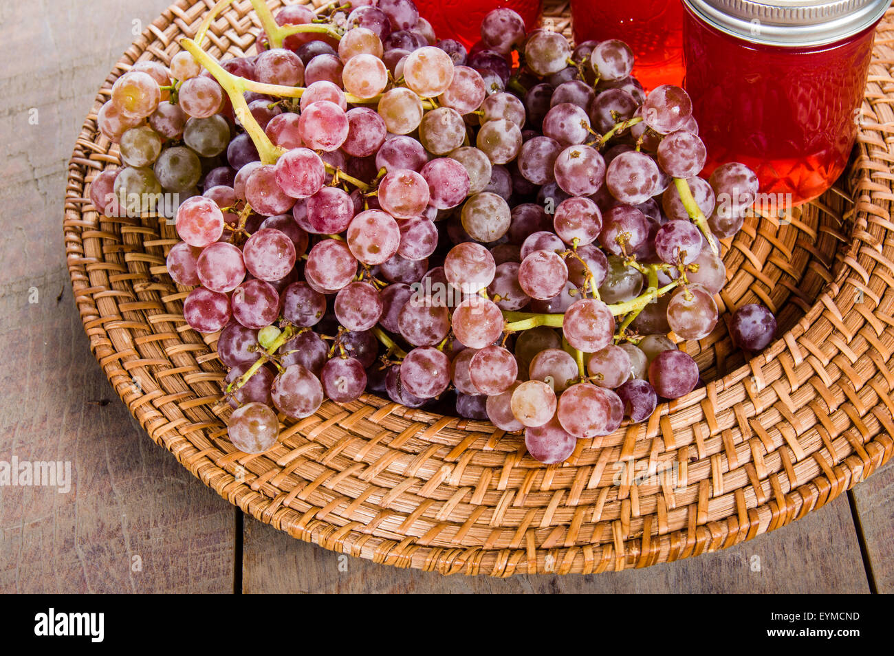Overhead of jars of fresh pink grape jelly with grapes Stock Photo - Alamy