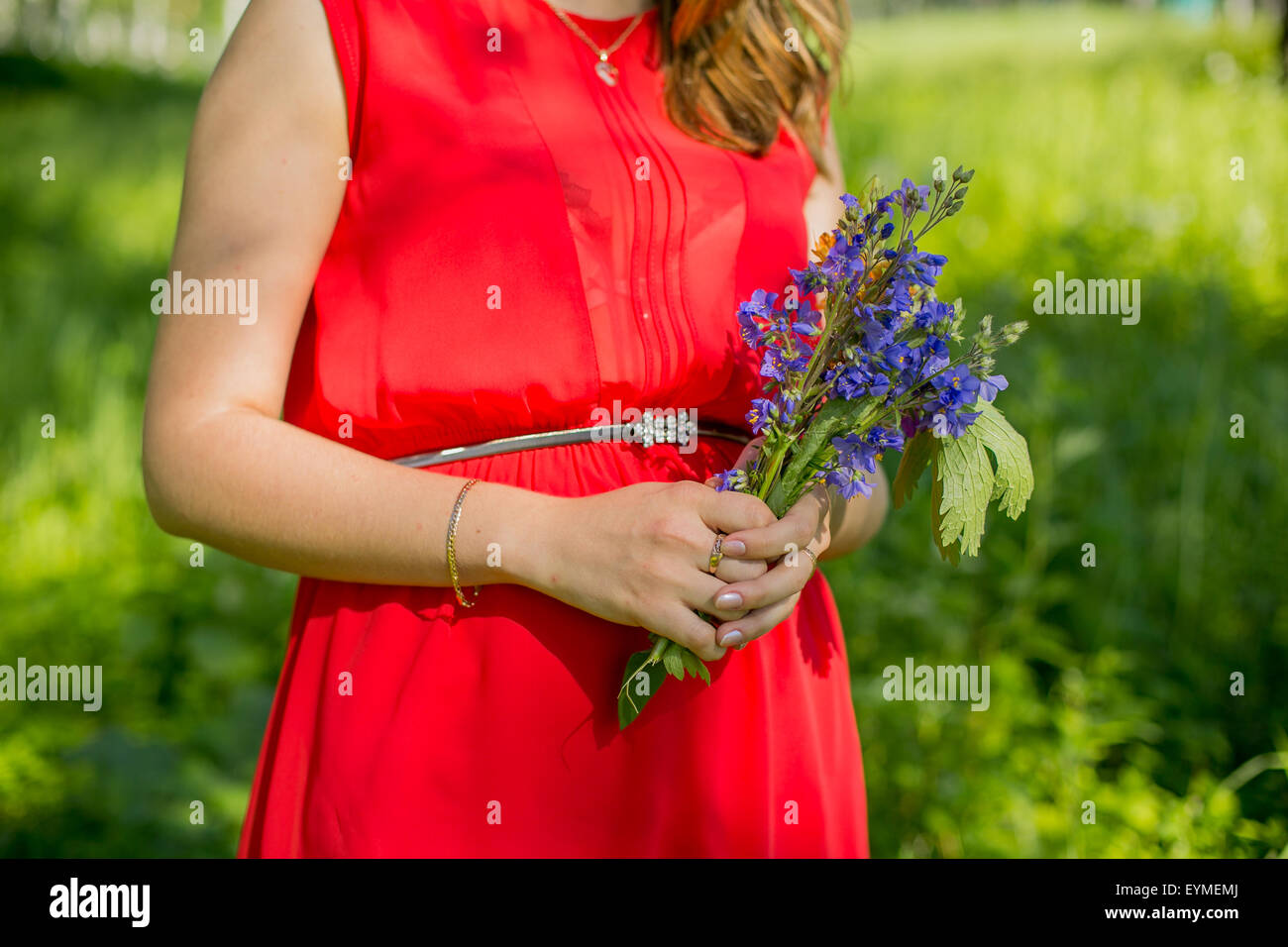 Blue flower bouquet in female hand Stock Photo - Alamy