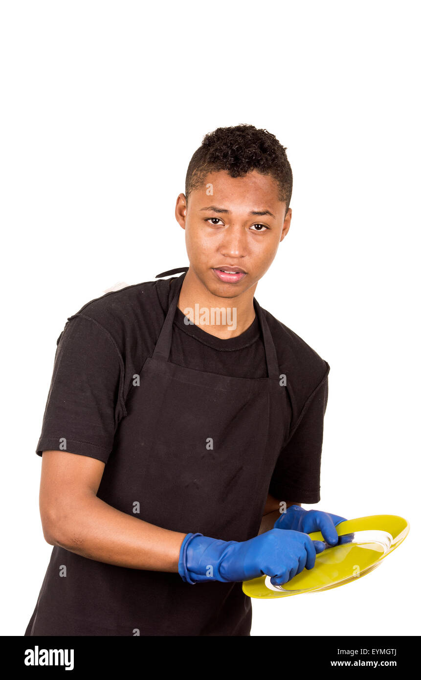 Hispanic young man wearing blue cleaning gloves washing a yellow plate ...